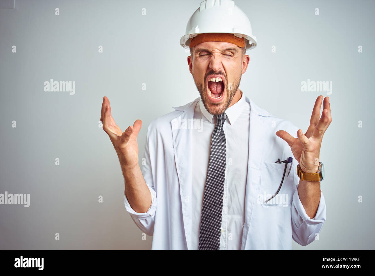 Young handsome engineer man wearing safety helmet over isolated ...