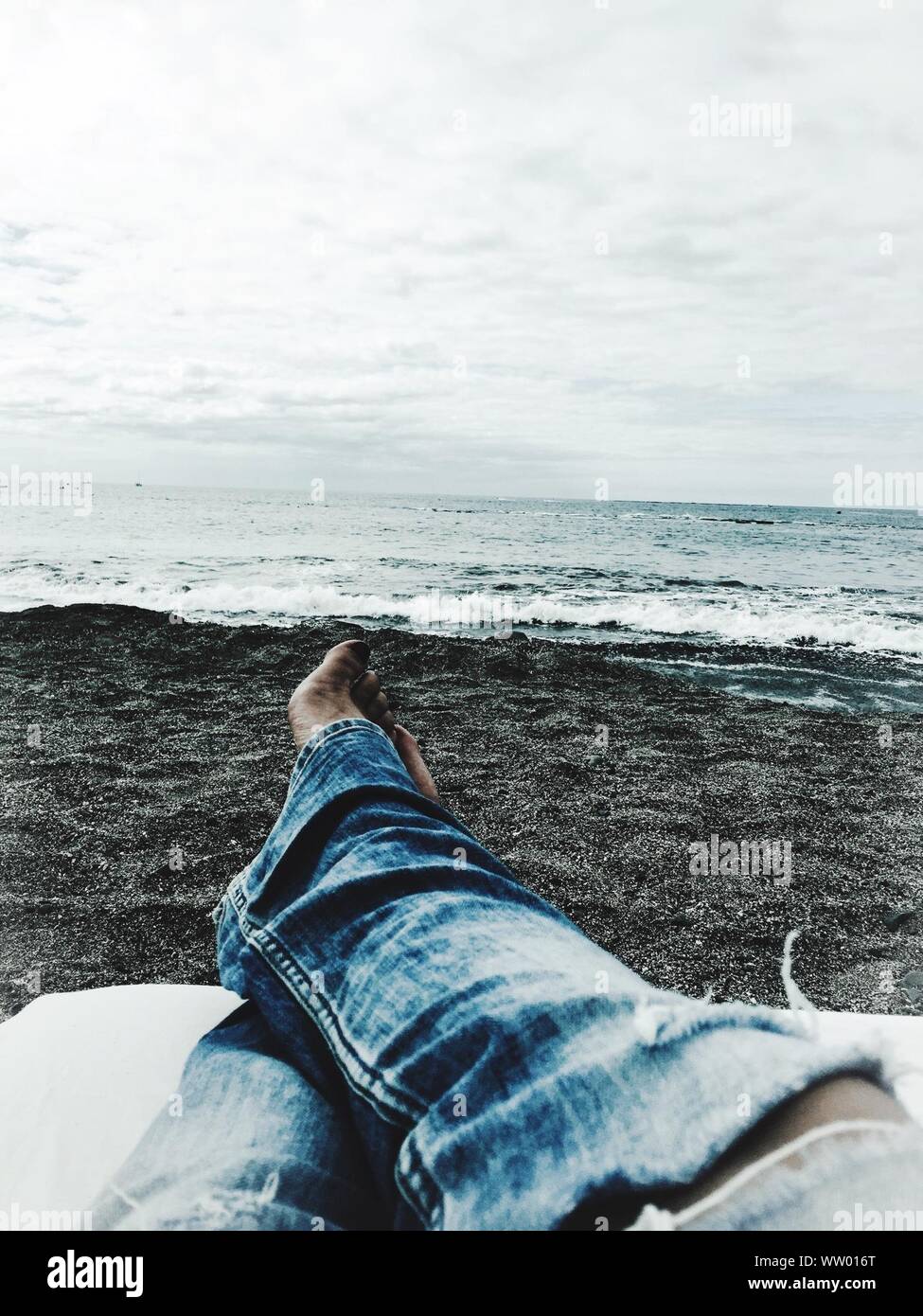 Woman lying down beach chair hi-res stock photography and images - Alamy