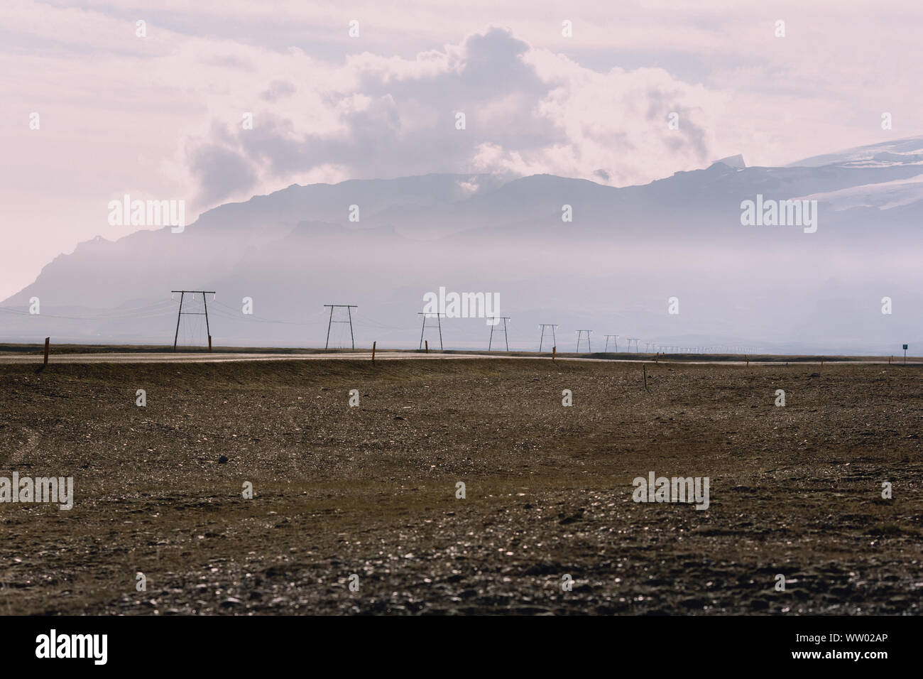 high-voltage electric poles located in the countryside. The lines are ...