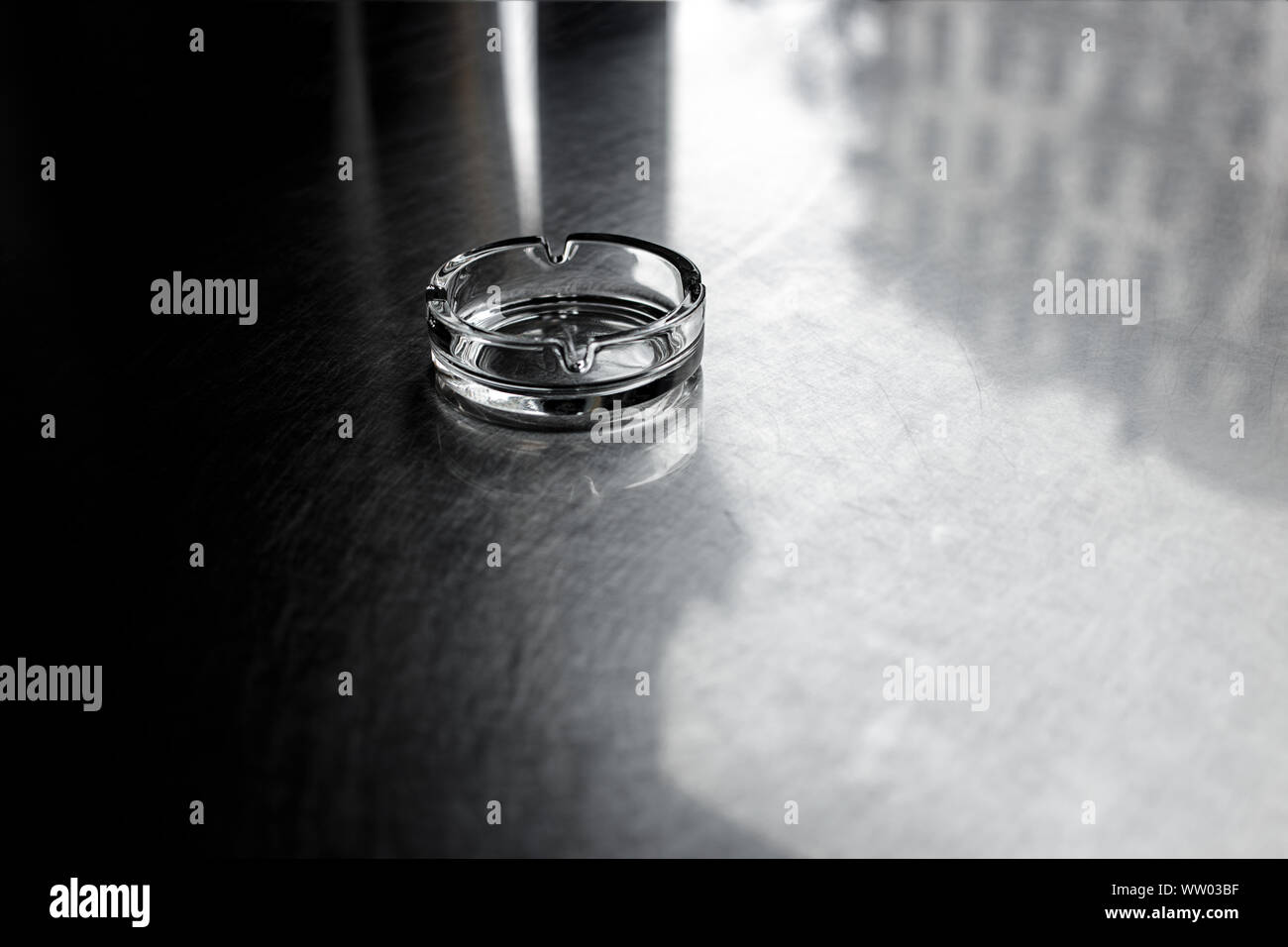 Glass empty ashtray on iron background. Space for text Stock Photo - Alamy
