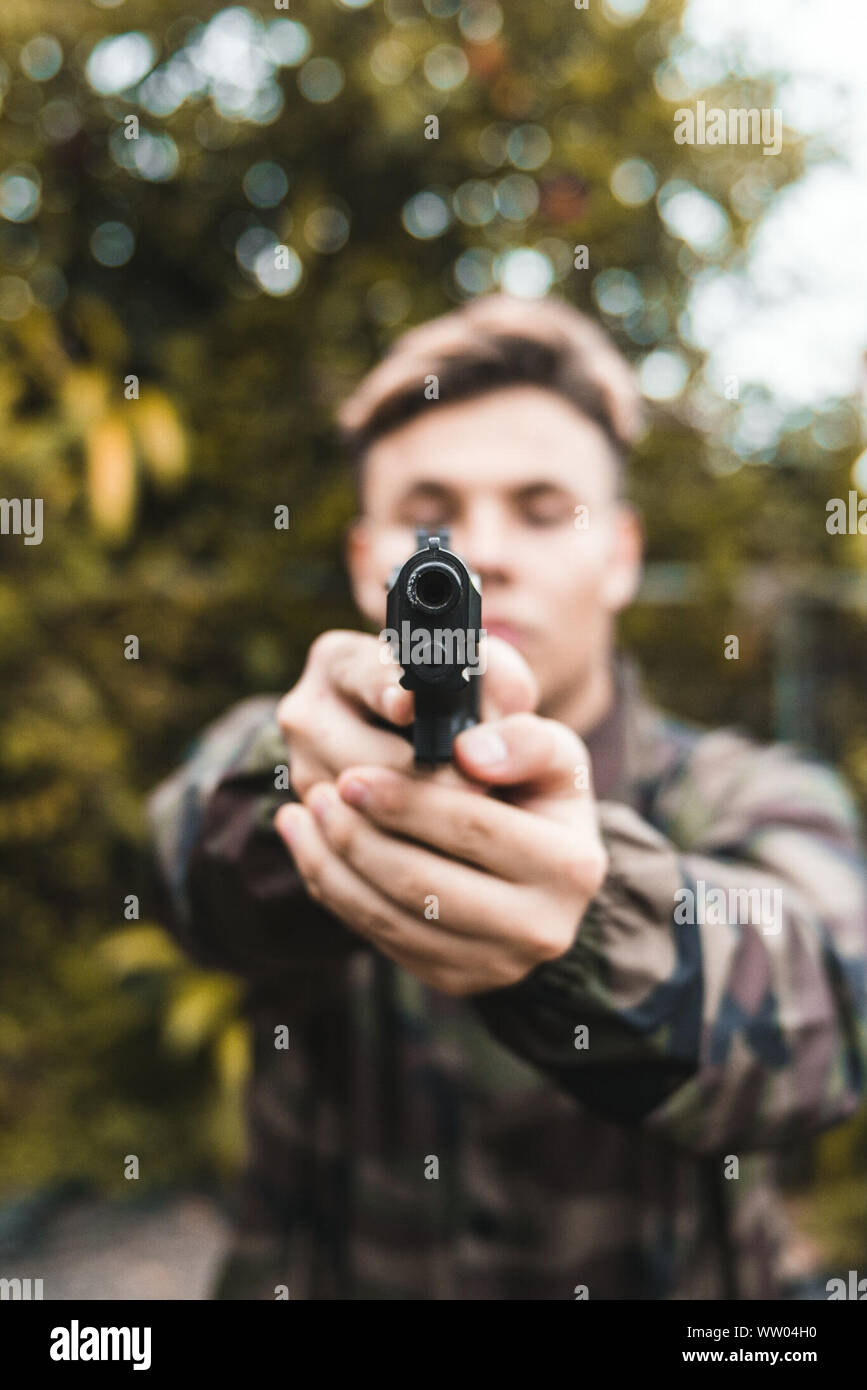 Young person shooting gun hi-res stock photography and images - Alamy