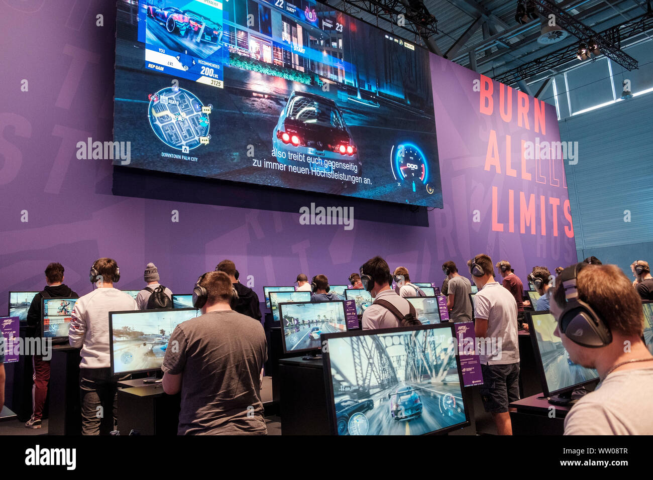 Gamers playing the car racing simulation video game „Need for Speed ...