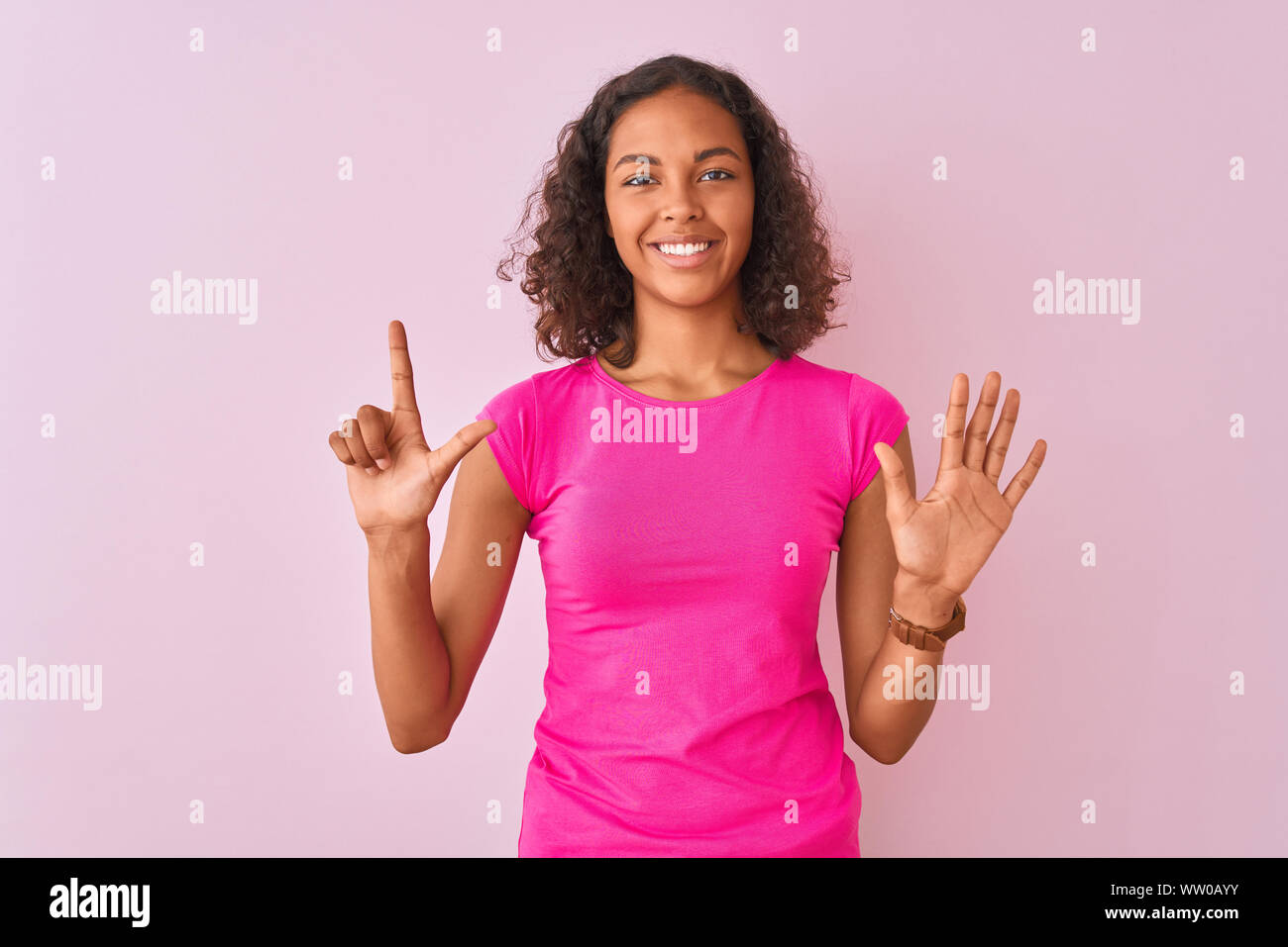 Young Brazilian Woman Wearing T Shirt Standing Over Isolated Pink