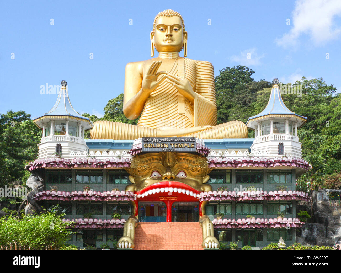 A large golden Buddha statue sits above the Uyanwatta Rajamaha Temple ...