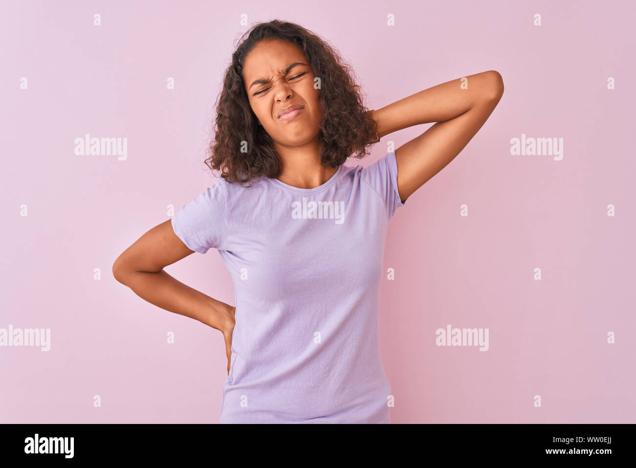 Young brazilian woman wearing t-shirt standing over isolated pink ...