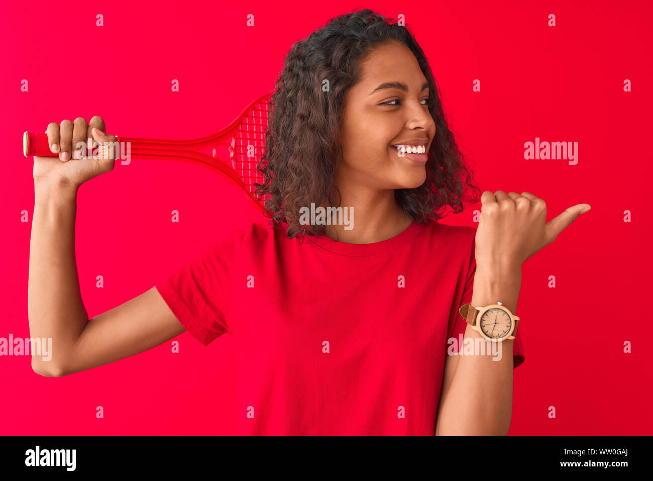 Young brazilian sportswoman holding tennis racket standing over ...