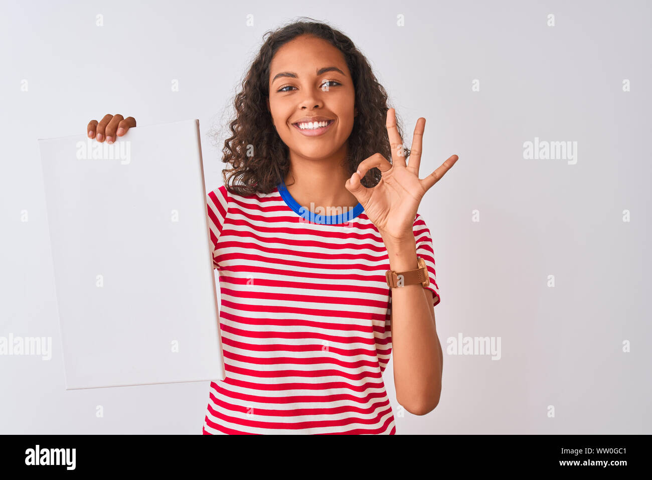 Young brazilian woman holding banner standing over isolated white ...