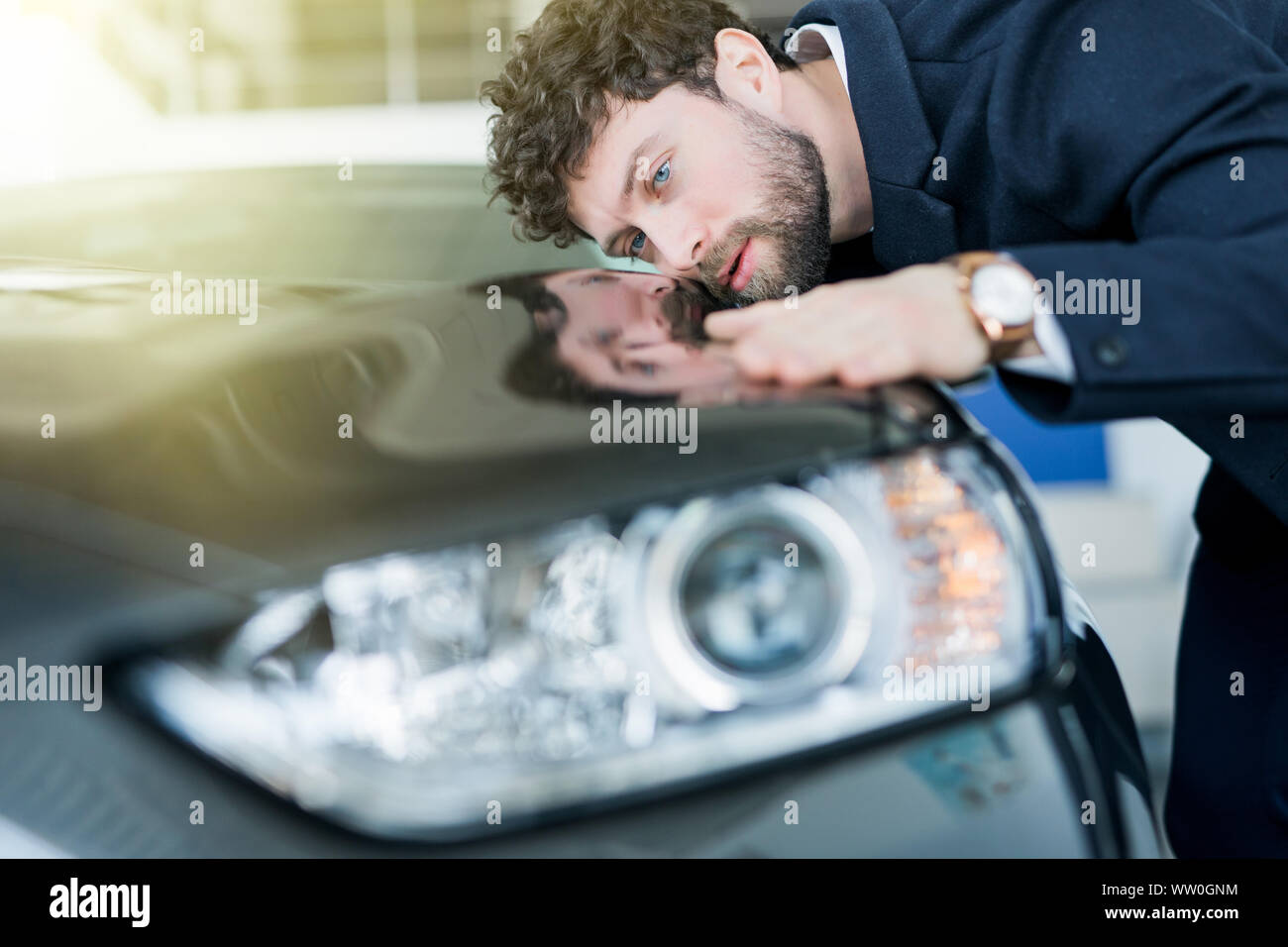 happy man touching car in auto show or salon Stock Photo - Alamy