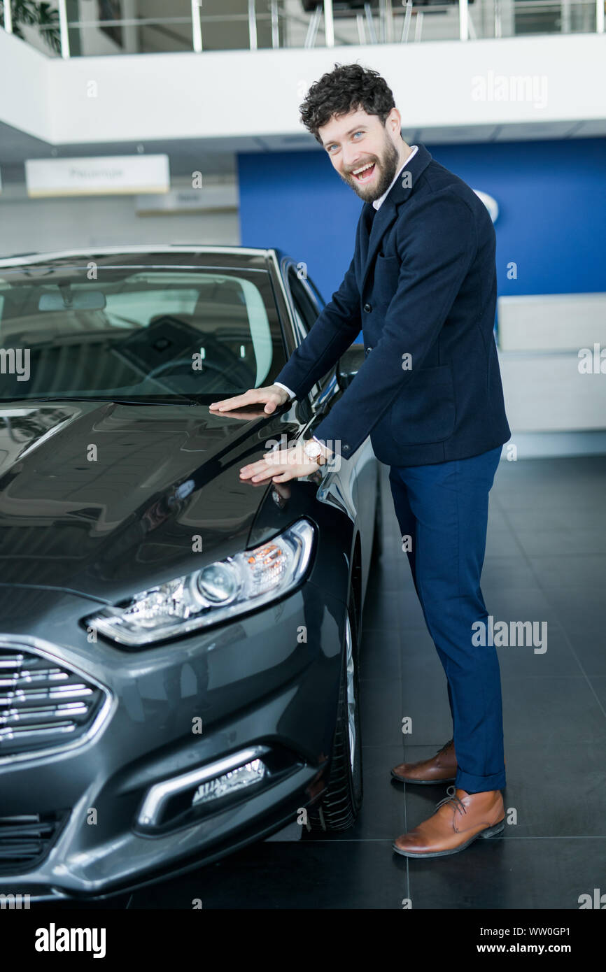 happy man touching car in auto show or salon Stock Photo - Alamy