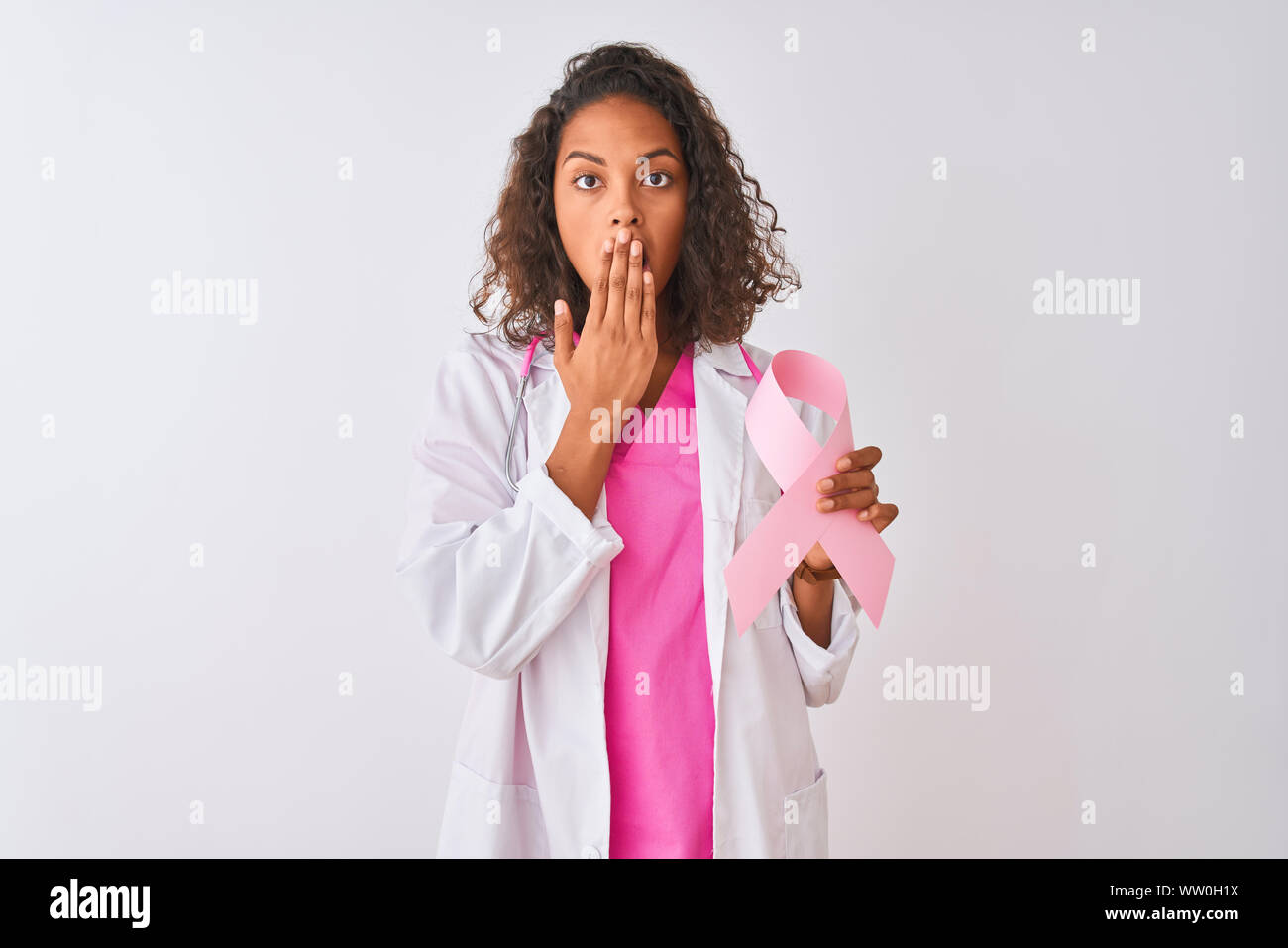 Young brazilian doctor woman holding cancer ribbon over isolated white ...