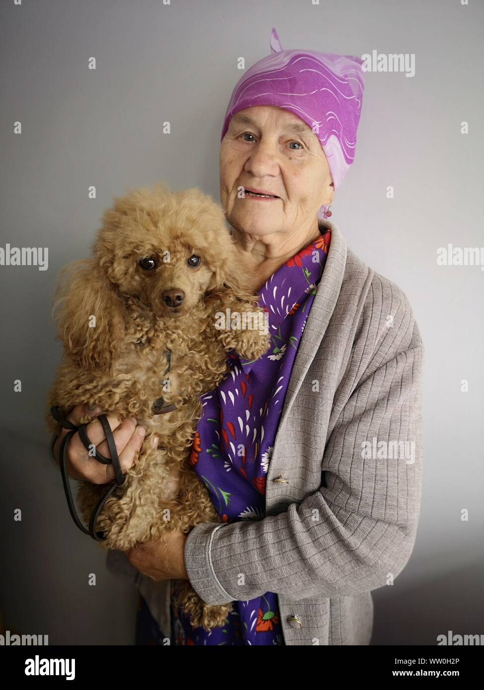 Senior woman hugging poodle dog Stock Photo - Alamy