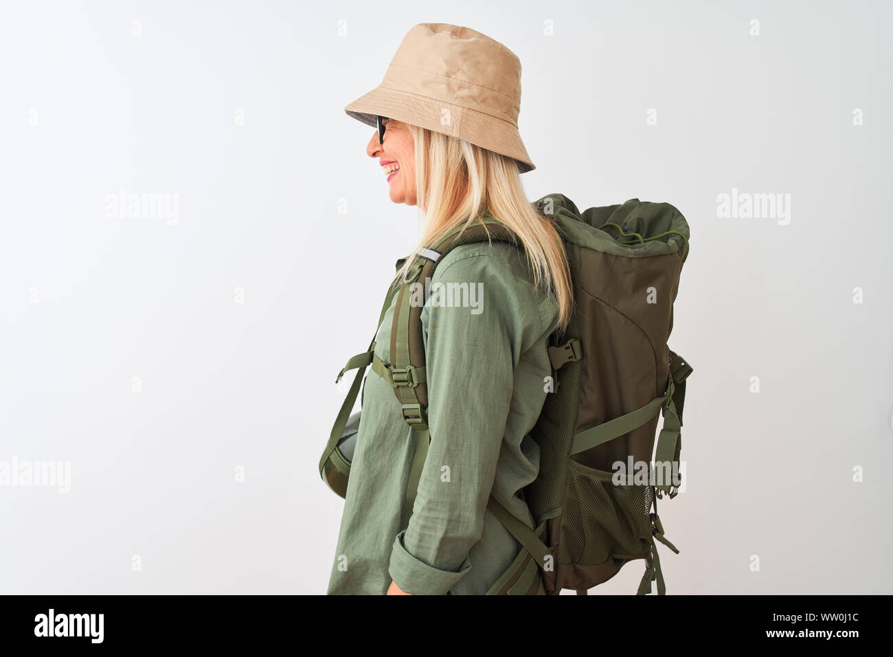 Middle age hiker woman wearing backpack hat canteen glasses over ...