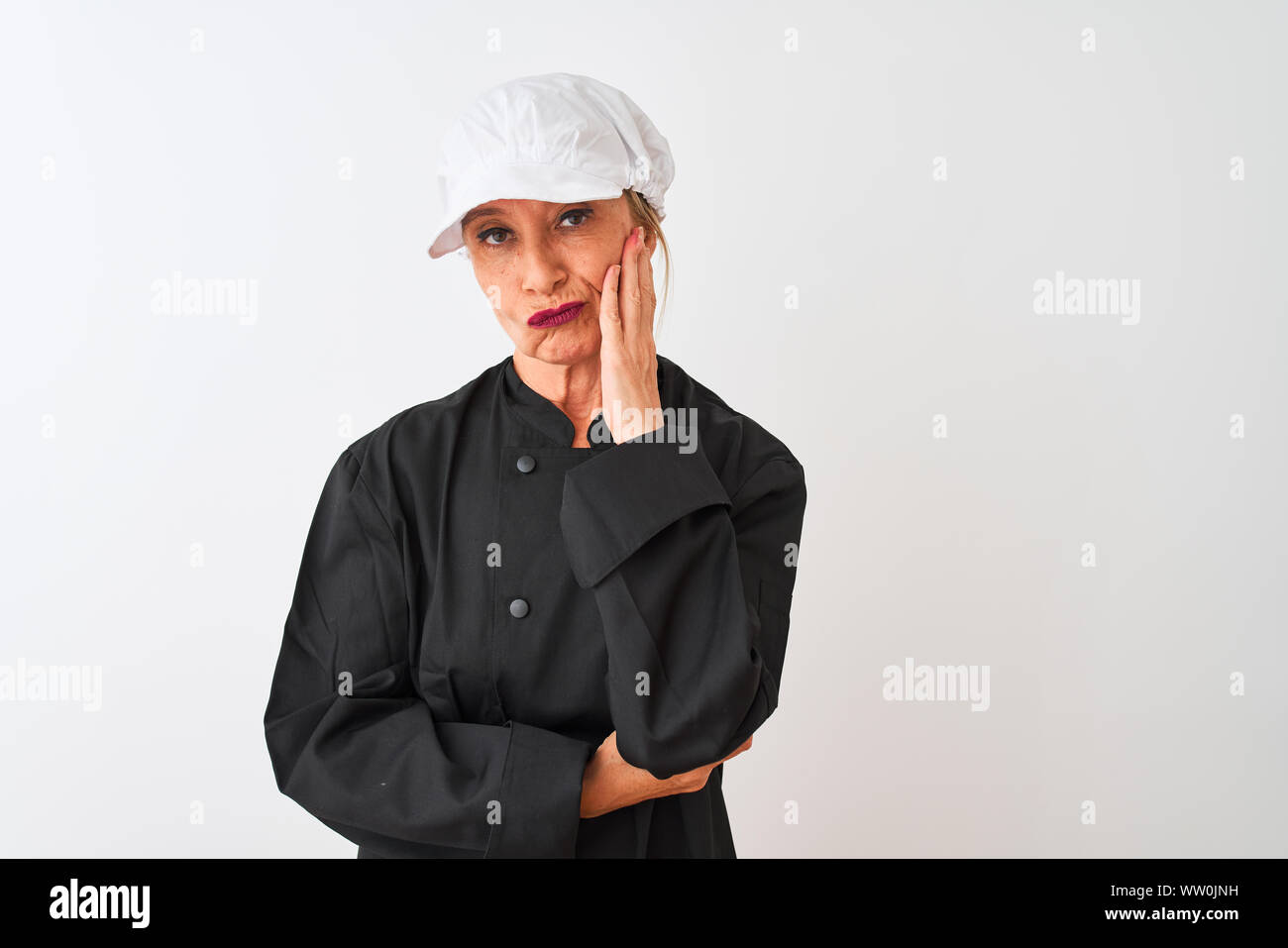 Middle age chef woman wearing uniform and cap standing over isolated ...