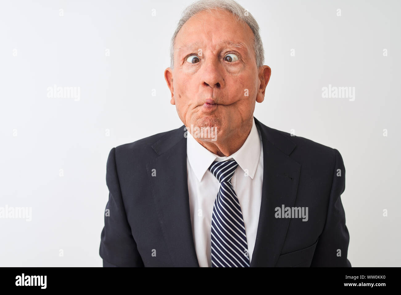 Senior grey-haired businessman wearing suit standing over isolated ...