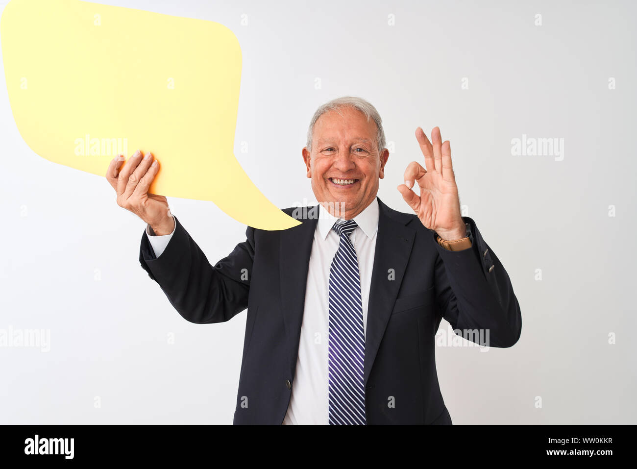 Senior grey-haired businessman holding speech bubble over isolated ...