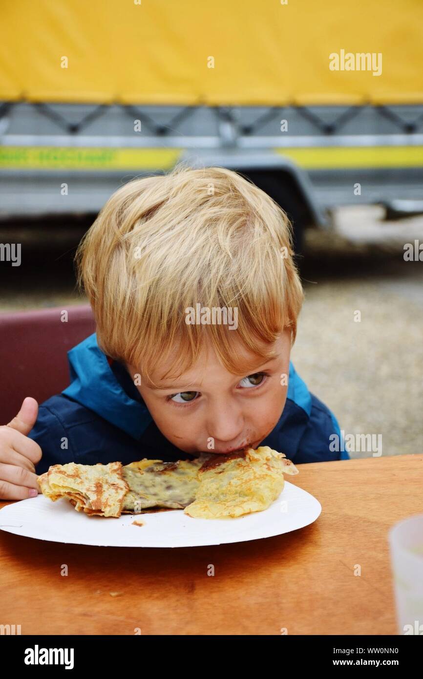 Blond boy eating table hi-res stock photography and images - Alamy
