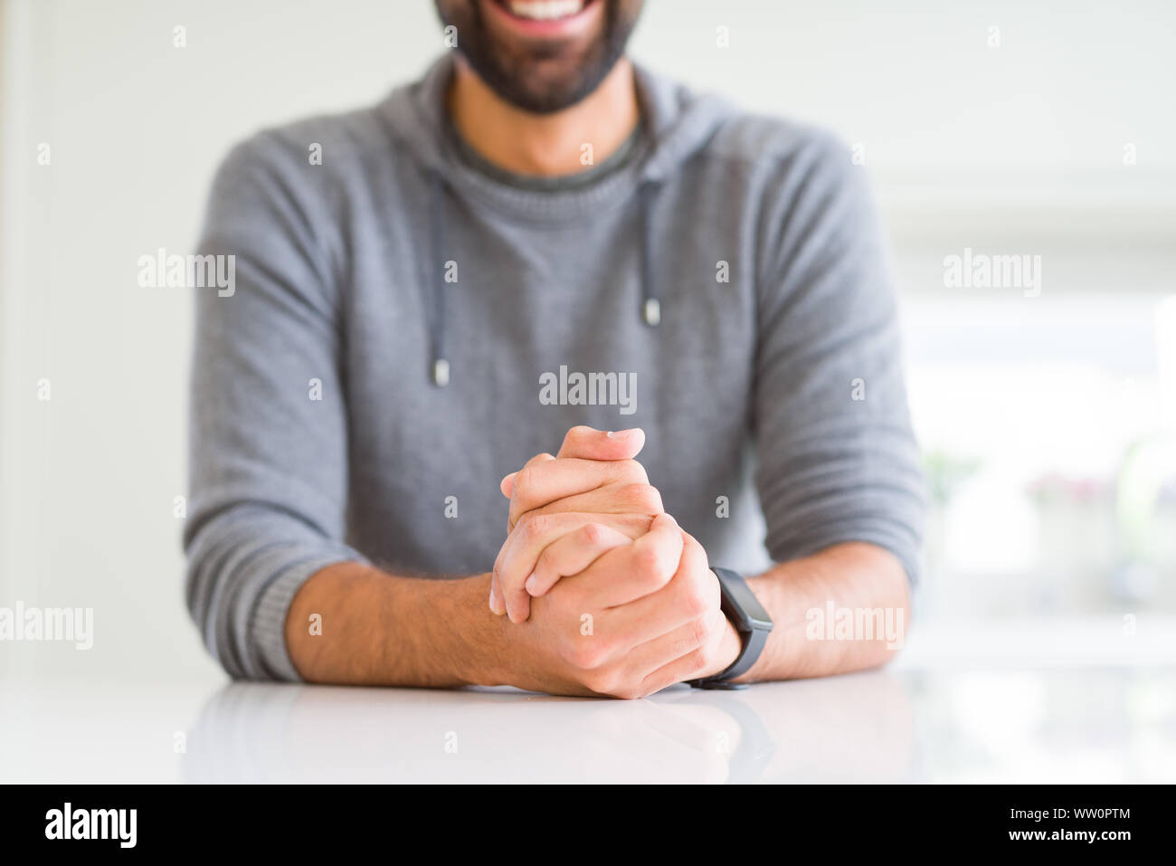 Business man smiling with hands over white table Stock Photo - Alamy