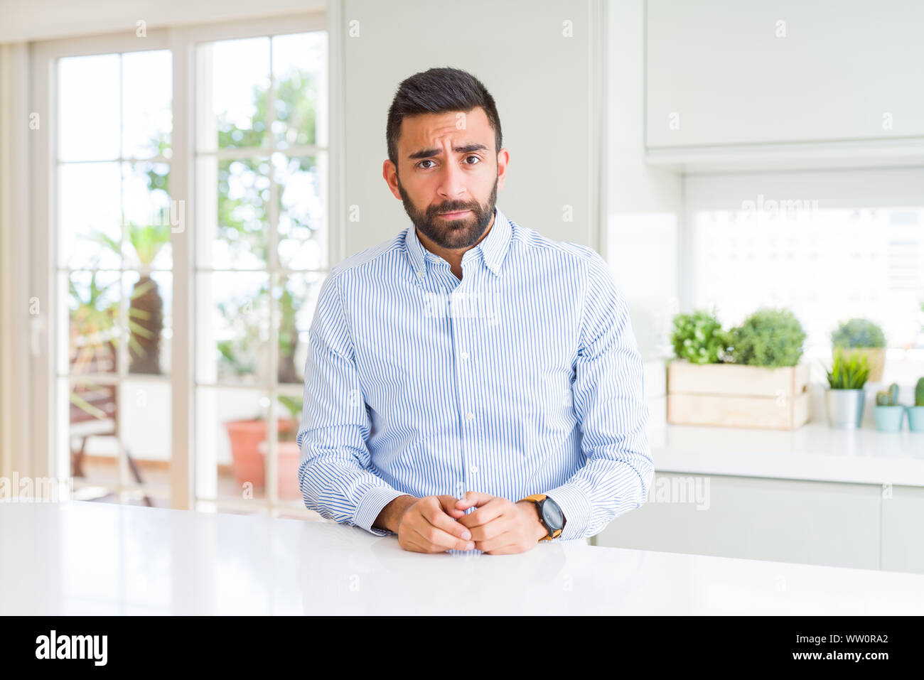 Handsome hispanic business man depressed and worry for distress, crying ...