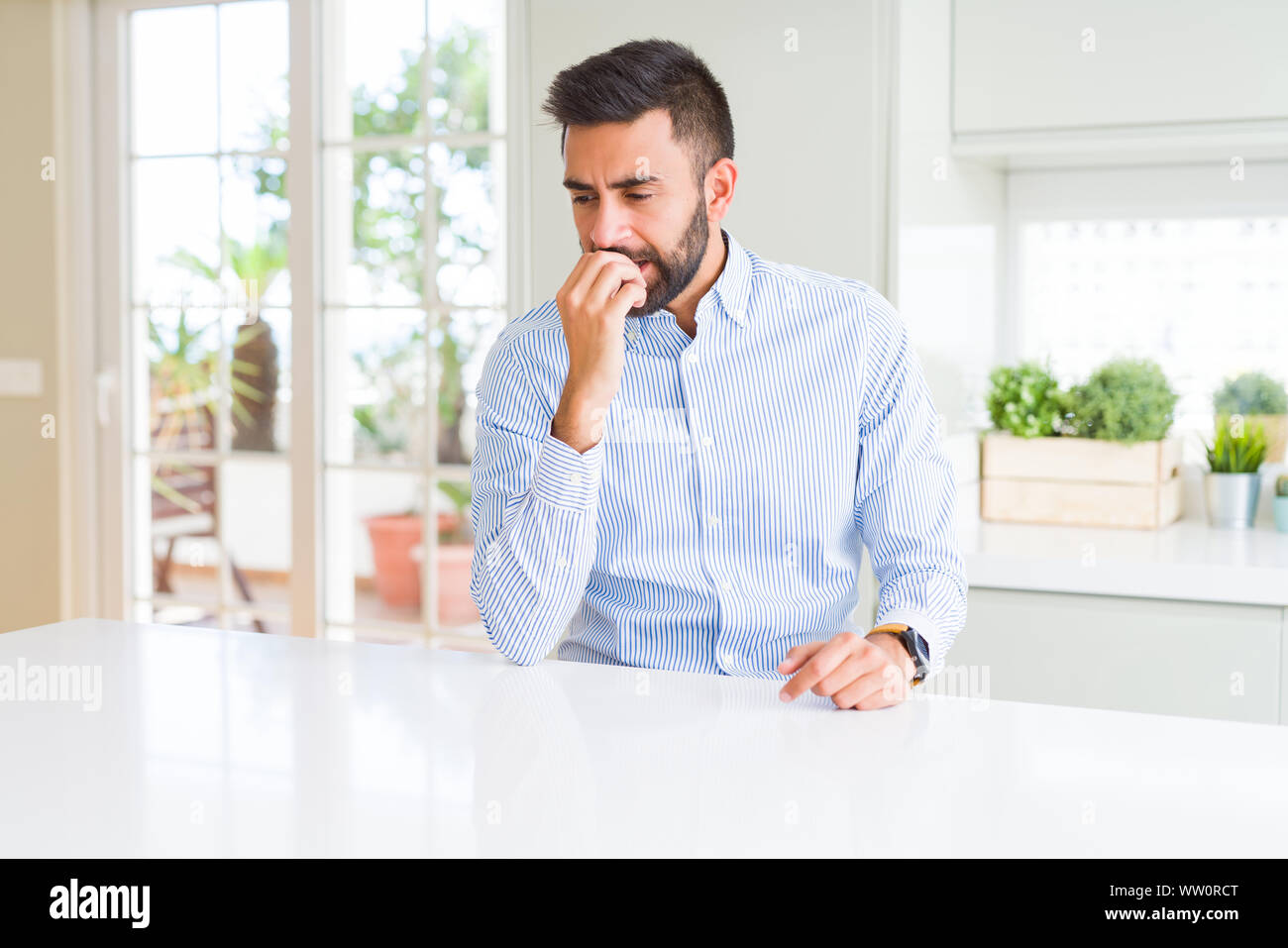Handsome hispanic business man looking stressed and nervous with hands ...