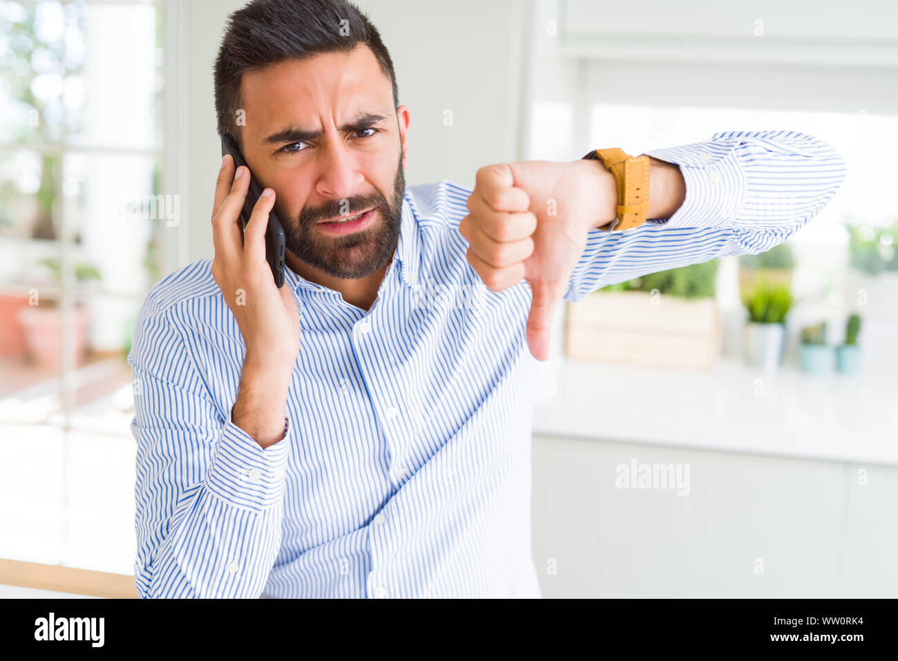 Handsome hispanic business man having a conversation talking on ...
