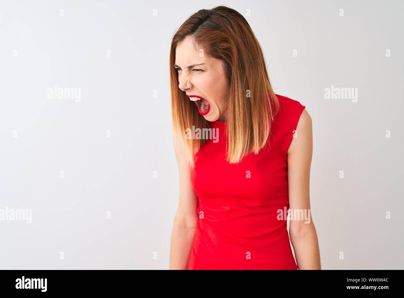 Redhead businesswoman wearing elegant red dress standing over isolated ...