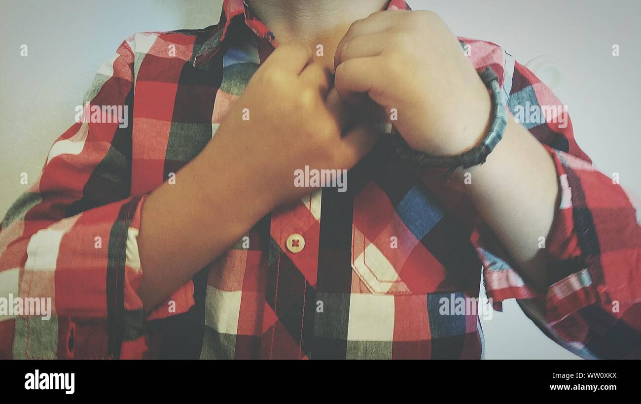 Boy buttoning his shirt hi-res stock photography and images - Alamy