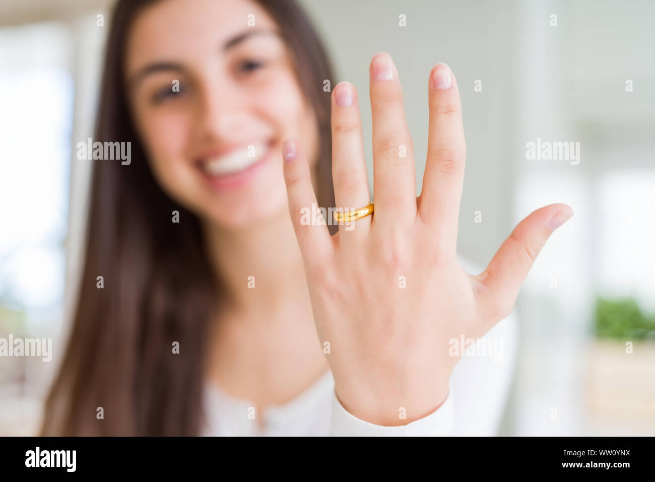 Beautiful young woman showing hand wearing wedding alliance ring Stock ...