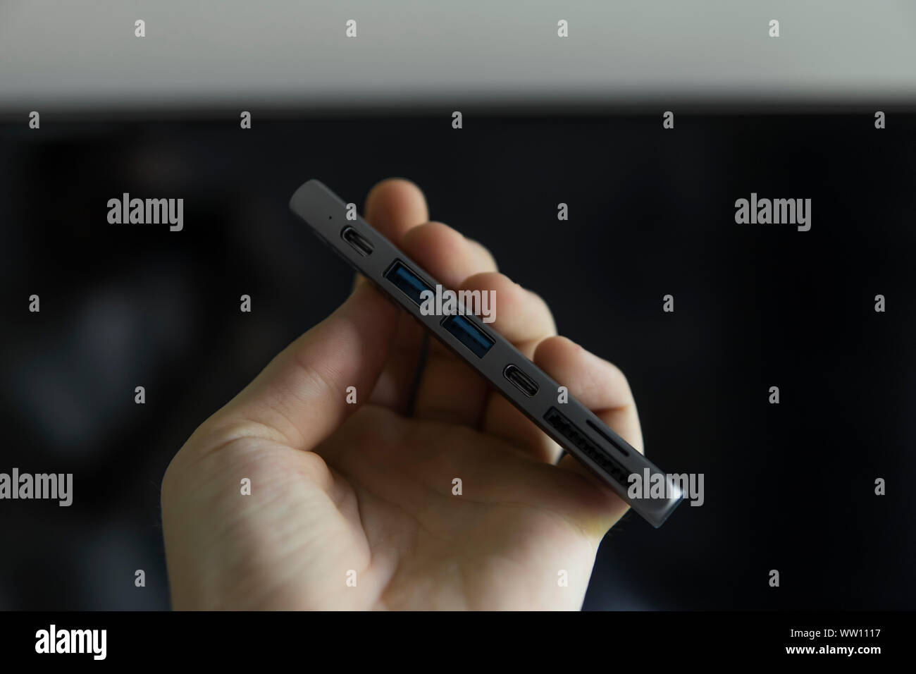 Man's hand holding The USB adapter under the Type-C connector for ...