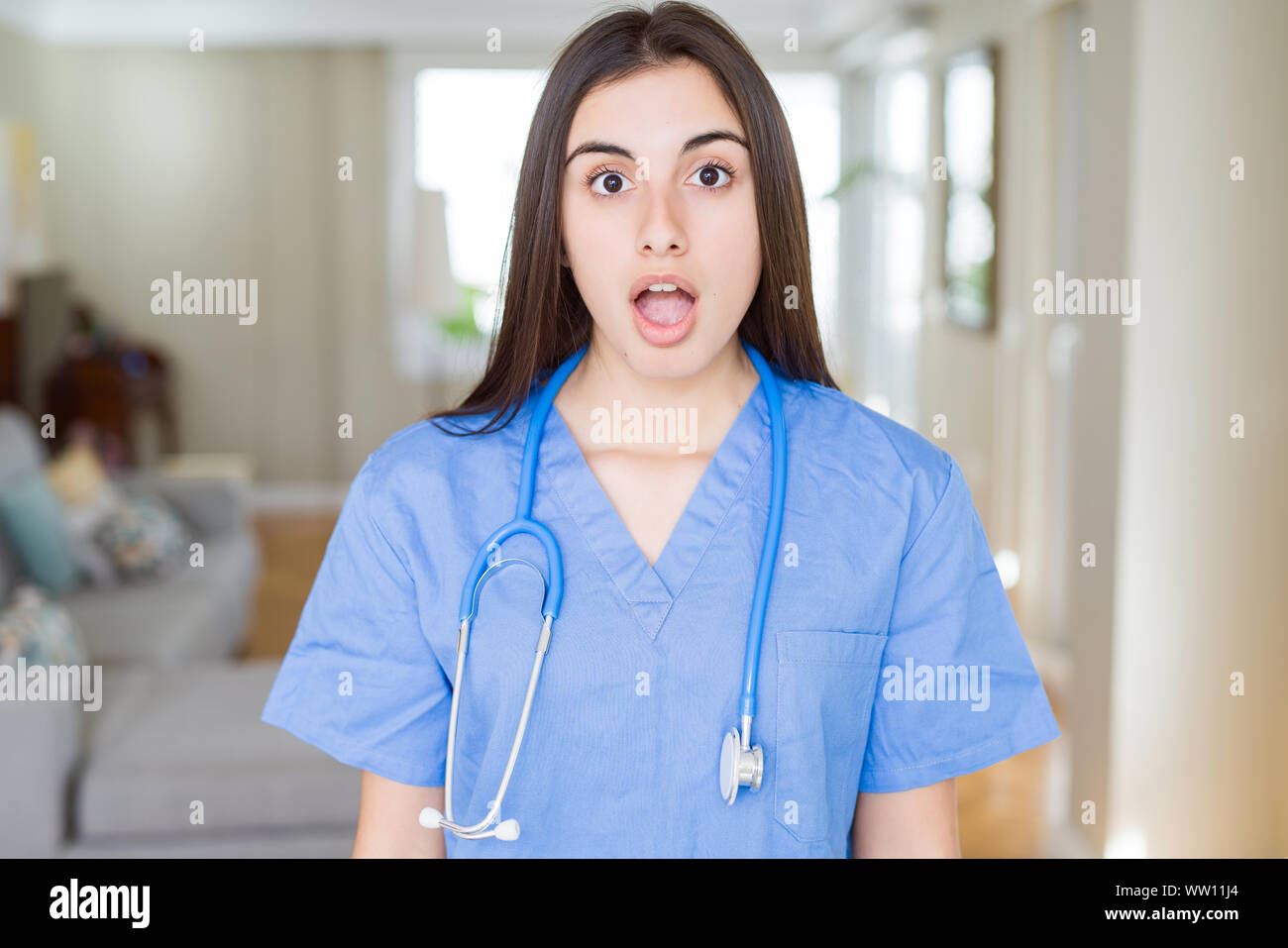 Beautiful young nurse woman wearing uniform and stethoscope at the ...