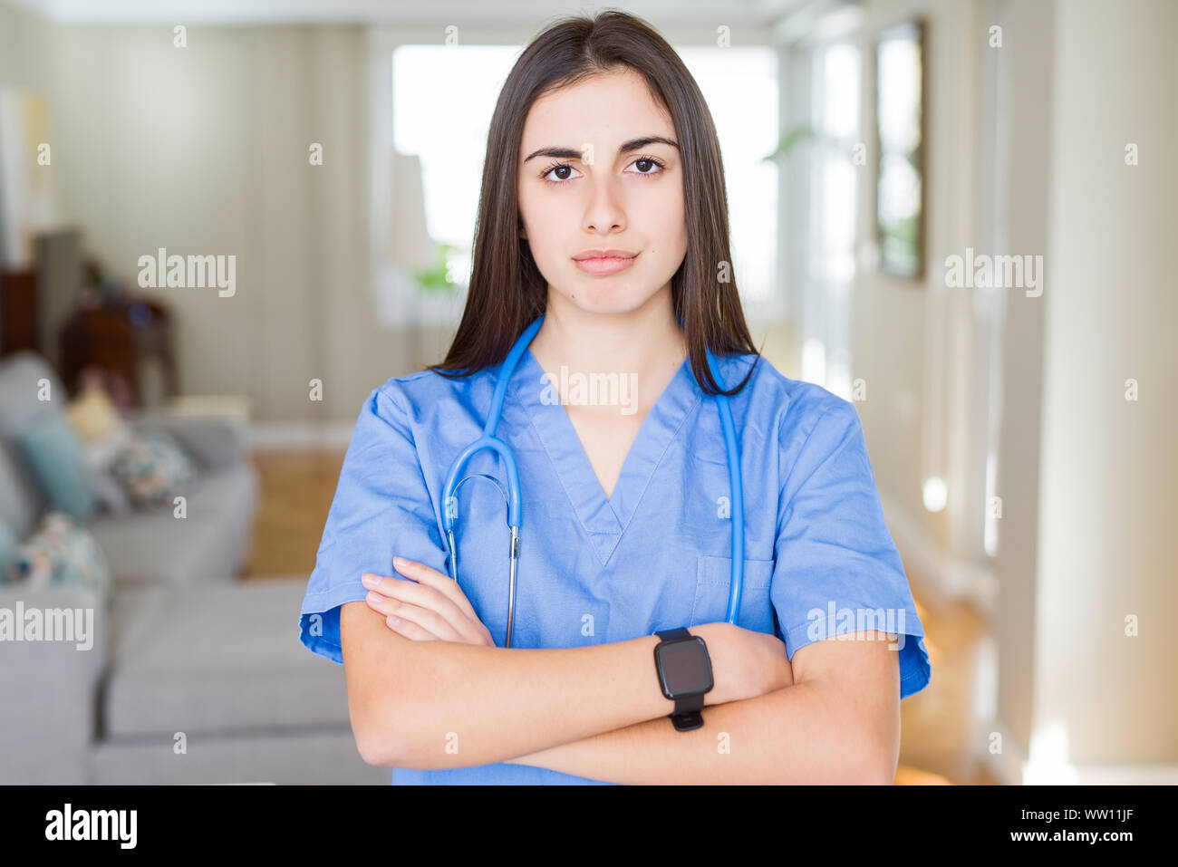 Beautiful young nurse woman wearing uniform and stethoscope at the ...