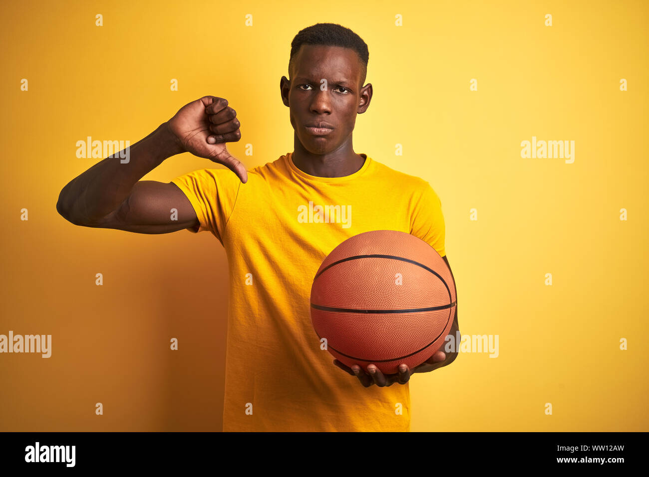 African american athlete man holding basketball ball standing over ...