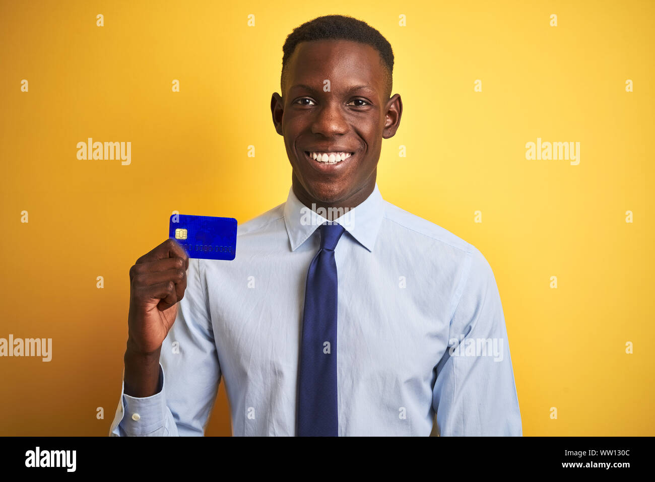 African american businessman holding credit card standing over isolated ...