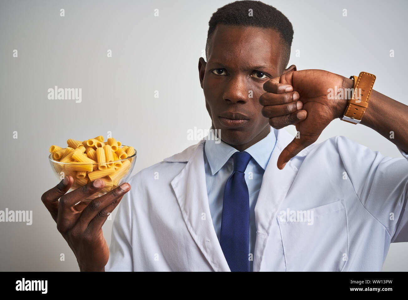 African american doctor man holding bowl with macaroni pasta over ...