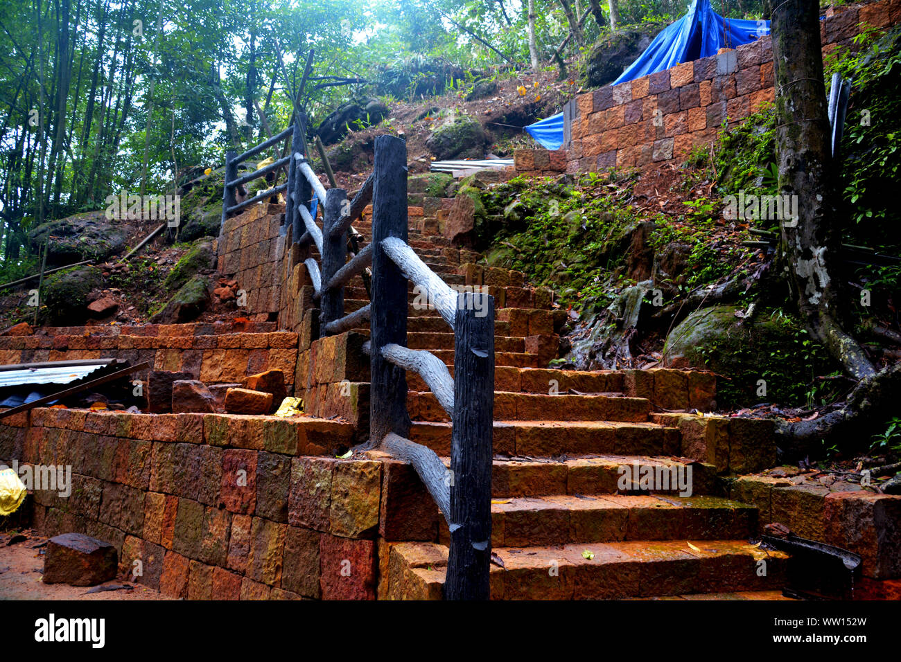 Small tree trunk railing made from cement concrete on stairs of cut ...