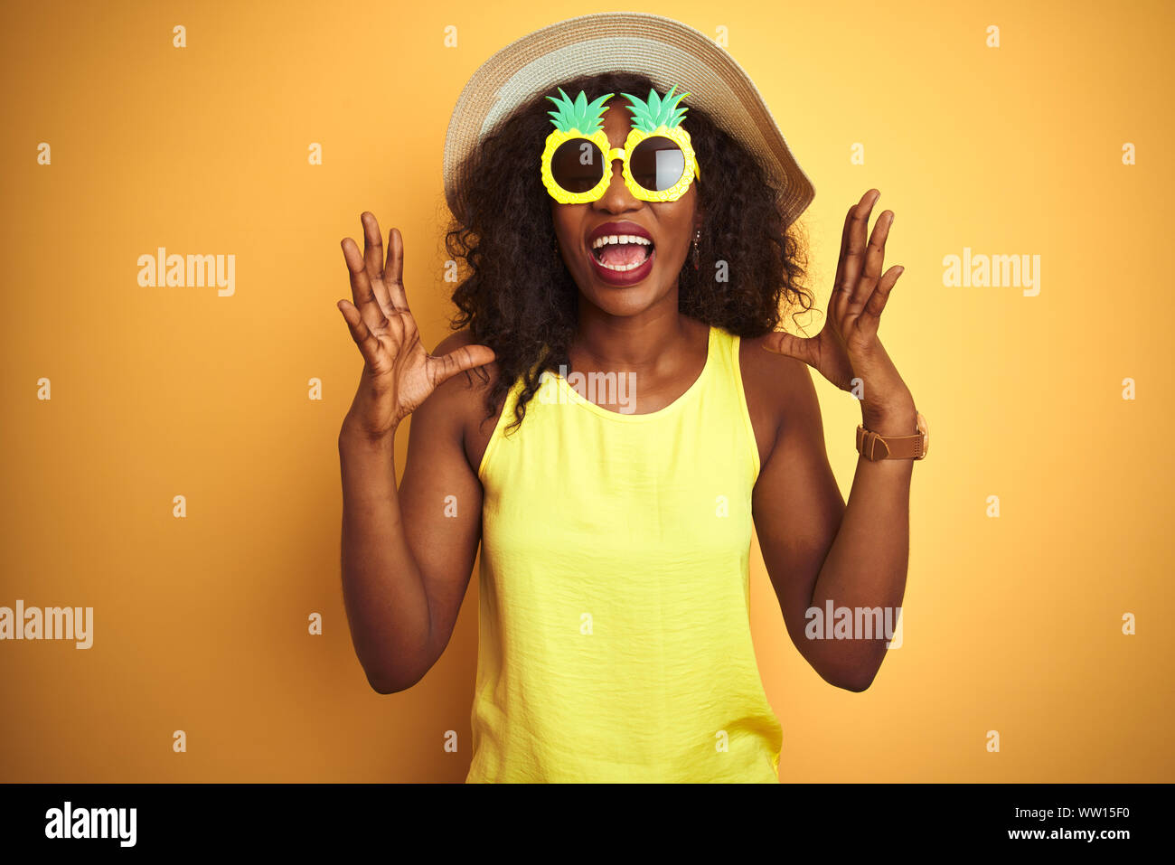 African american woman wearing funny pineapple sunglasses over isolated ...