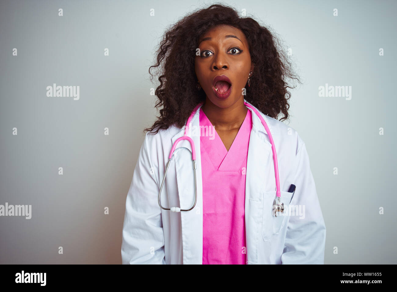 African american doctor woman wearing pink stethoscope over isolated ...