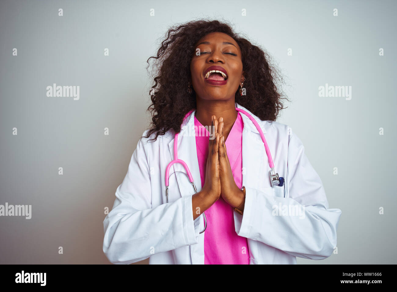 African american doctor woman wearing pink stethoscope over isolated ...