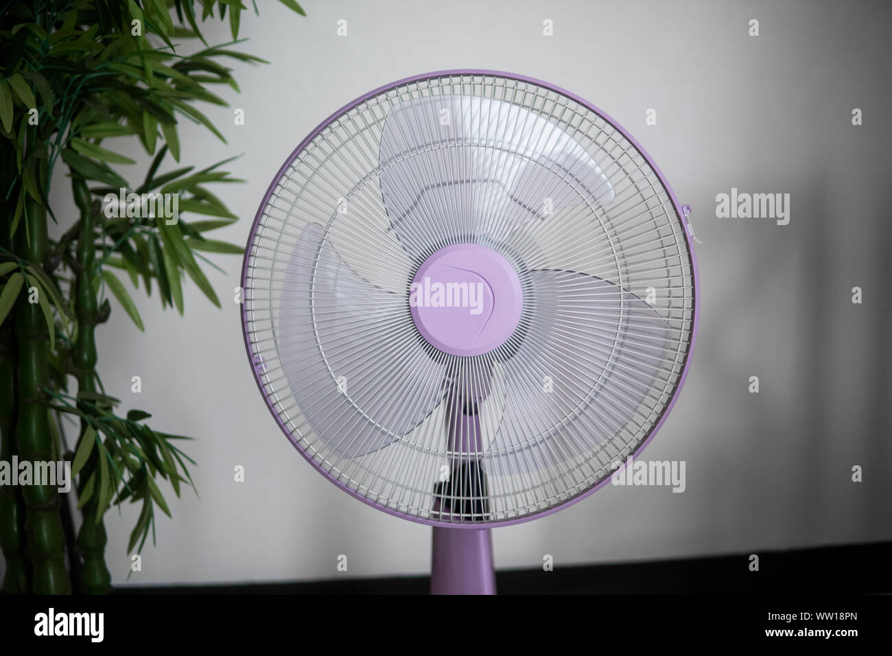 Modern violet electric fan in a living room saving peoples from hot ...