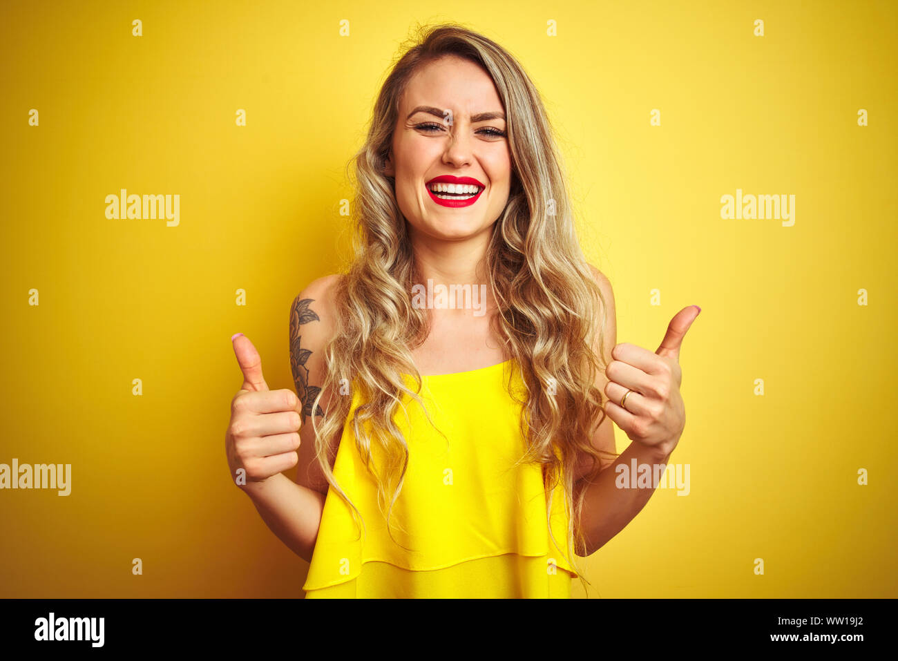 Young attactive woman wearing t-shirt standing over yellow isolated ...
