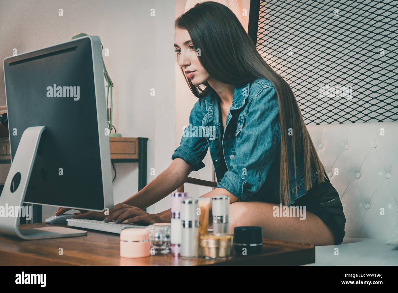 Casual woman working on her iMac pro at home Stock Photo - Alamy