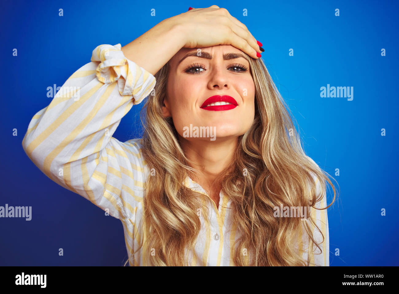 Young Beautiful Woman Wearing Striped Shirt Standing Over Blue Isolated