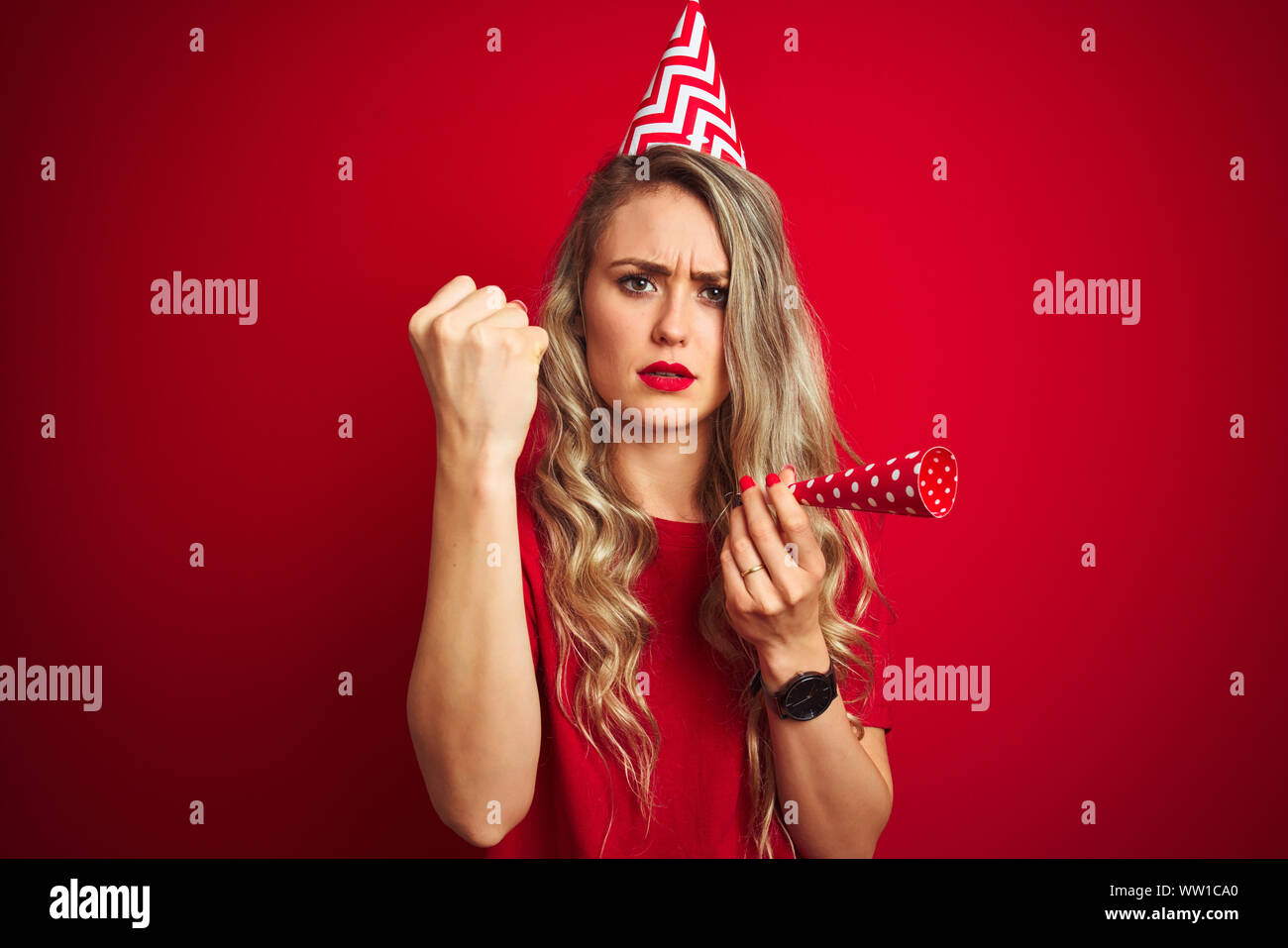 Young beautiful woman on birthday celebration over red isolated ...