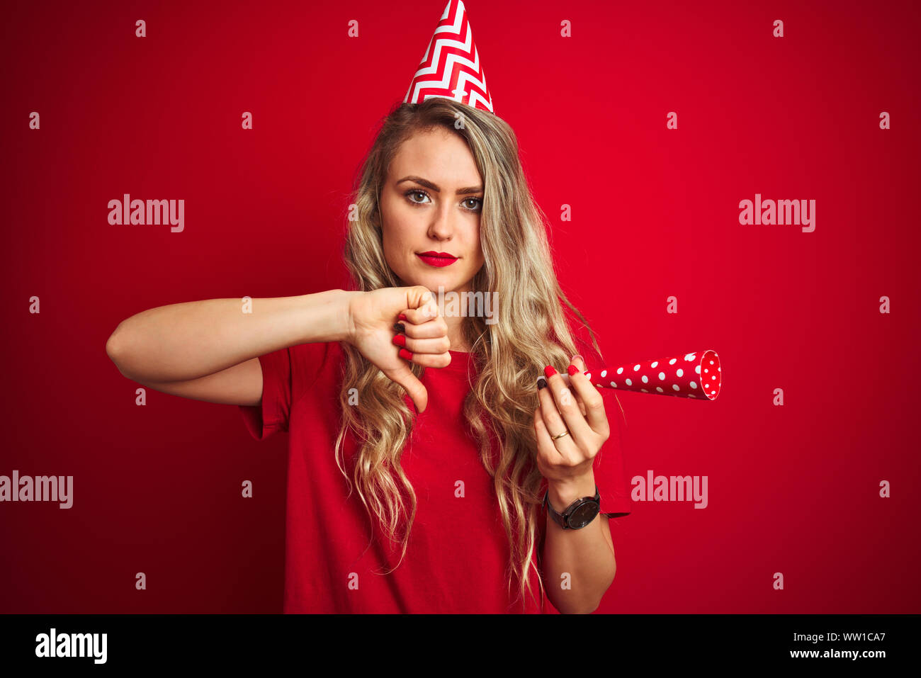 Young beautiful woman on birthday celebration over red isolated ...