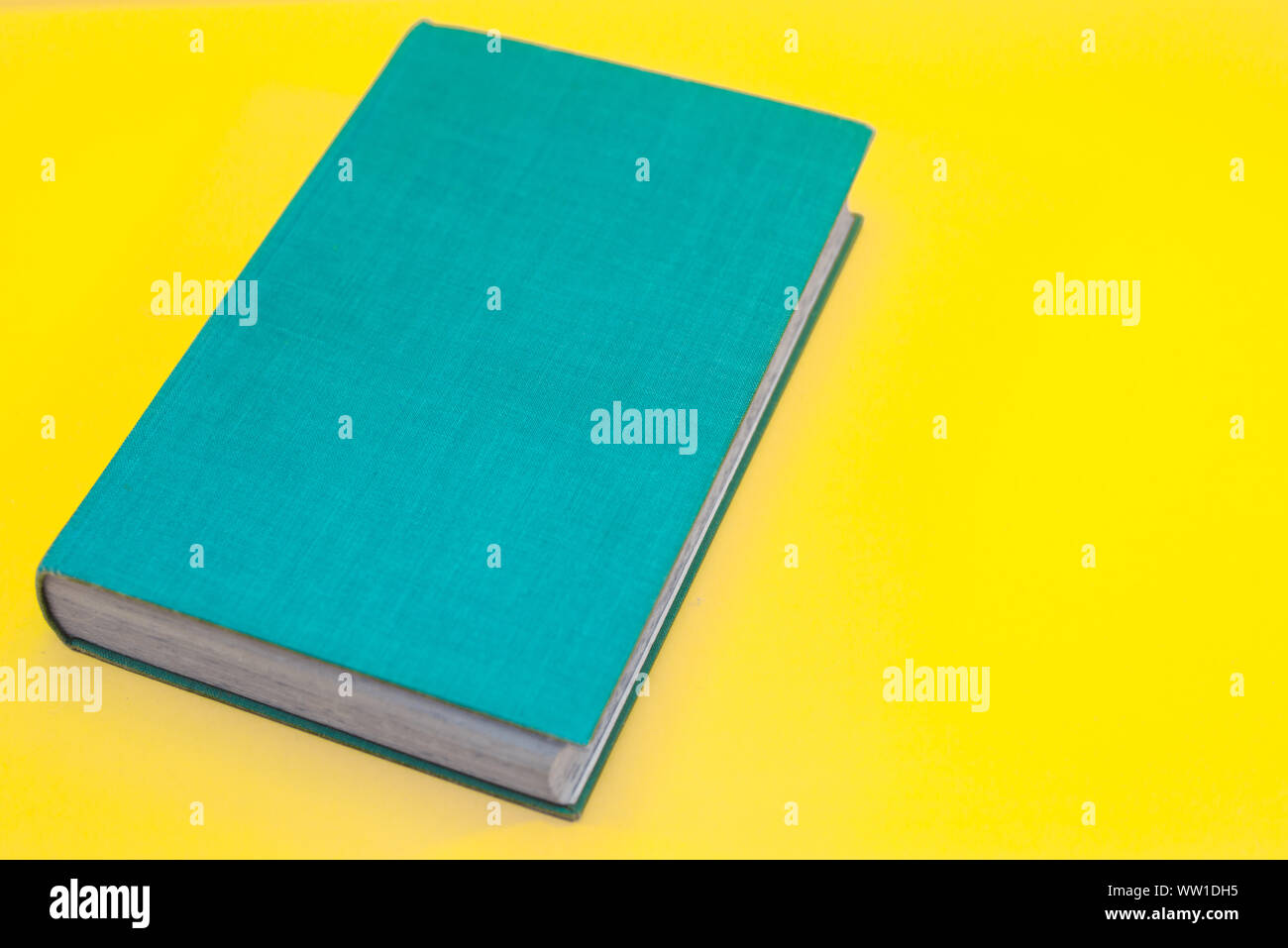 Turquoise Vintage Book WIth Vibrant Yellow Background Stock Photo - Alamy