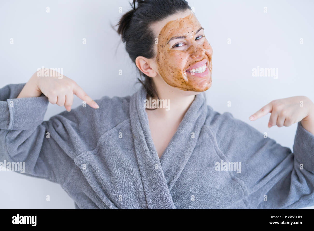 Beautiful young woman wearing cosmetic facial mask as skincare beauty treatment looking ...