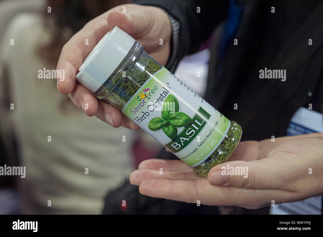 Savor Tree Herbal Crystals, close-up of woman's hand holding a basil ...