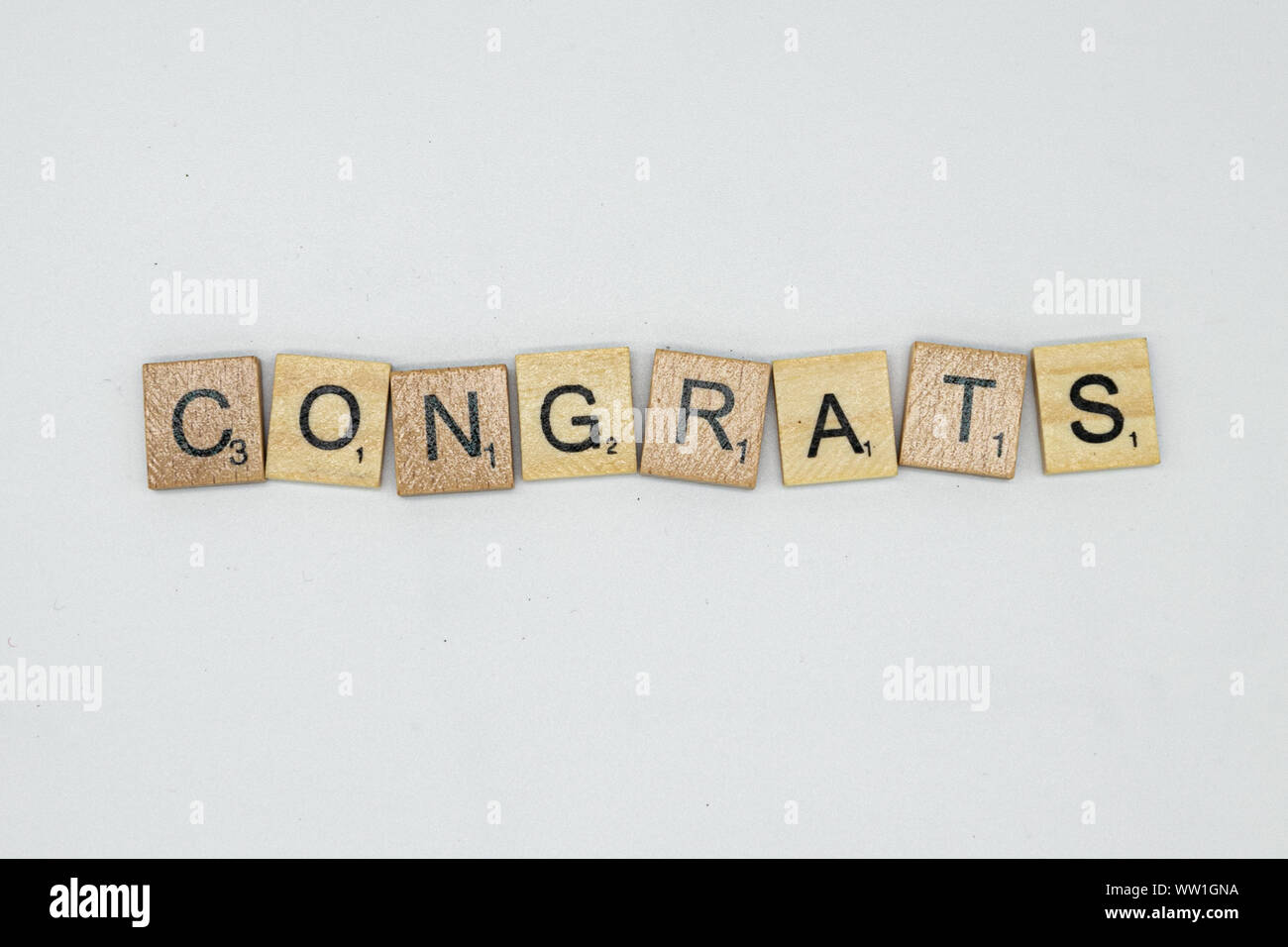Isolated congratulations message spelt in scrabble letters on white ...