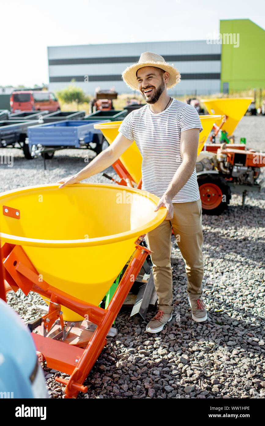 Agronomist choosing a new planter for farming at the outdoor ground of ...