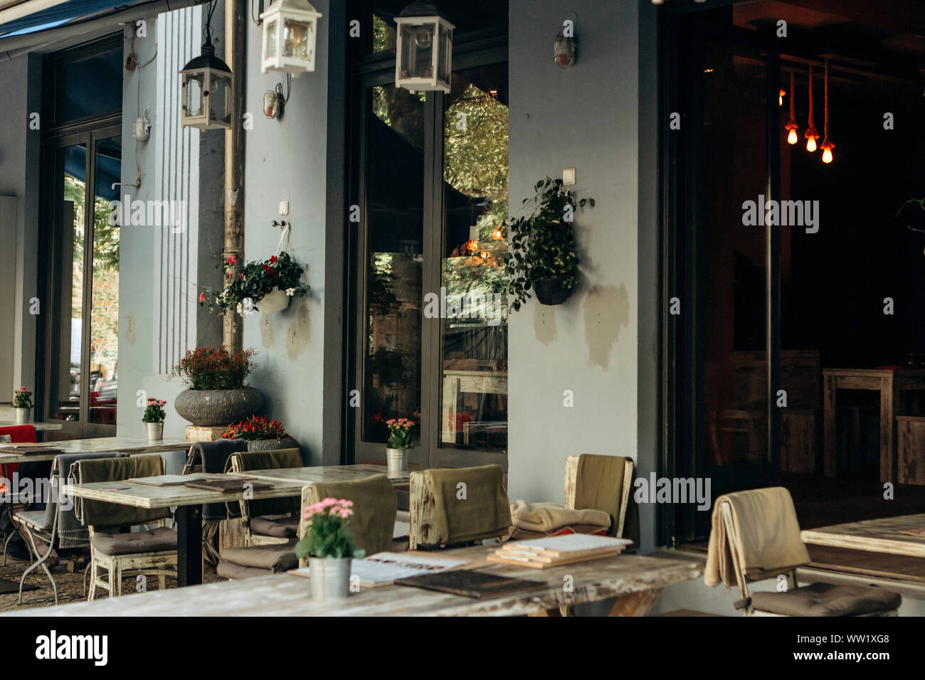 Empty street cafe with wooden tables. Waiting for customers Stock Photo ...
