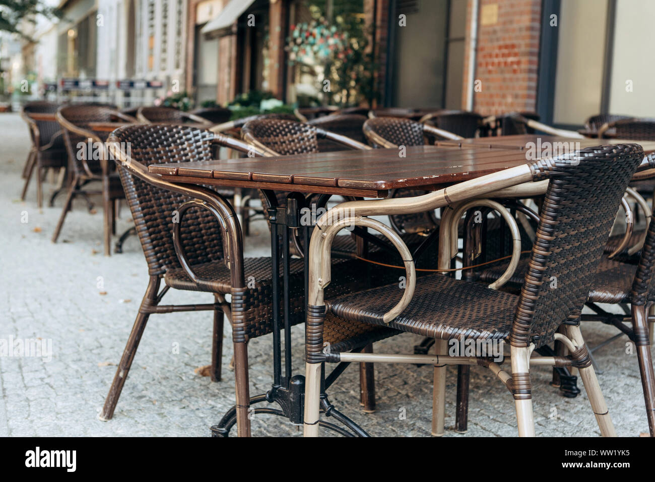 Empty tables and chairs of a street cafe Stock Photo - Alamy